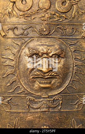 Character faces on copper metal plates Stock Photo - Alamy