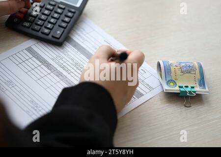 Accountant start to fill Iranian tax form on office table. Taxation ...