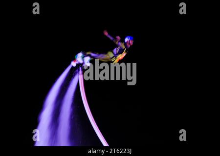 Water stunts performance at night in a park Stock Photo - Alamy