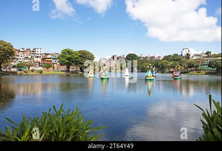 Sculptures of African deities on the natural spring lake Dique do ...