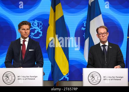 Finland's Defense Minister Antti Hakkanen, left center, speaks with ...