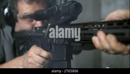 Firing an Assault rifle in super slow-motion 800 fps. Person shooting ...