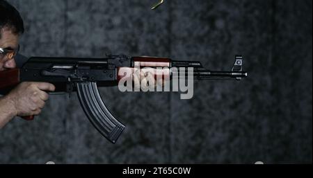 Side view of person shooting an AK-47 Rifle in high-speed 800 fps. Slow ...