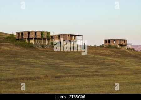 Abandoned buildings in the village of Voskepar. Mountain in the ...