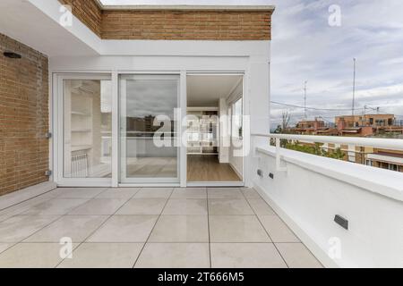 Terrace with white stoneware floor, large window with three aluminum ...