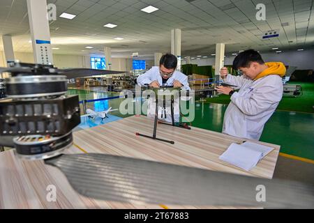 Workers assemble products at a factory in Yangzhou City, east China's ...