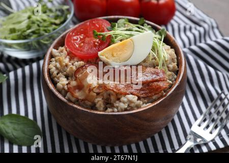 Delicious boiled oatmeal with egg, bacon, tomato and avocado isolated ...