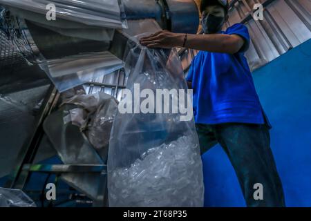 Workers pack crystal ice cubes at a crystal ice cube factory in Bogor ...