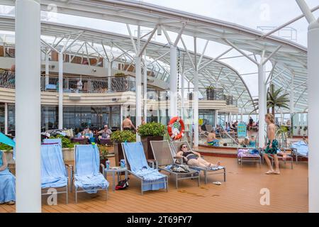 Adult cruise passengers enjoying the pool at the Solarium on the Royal ...