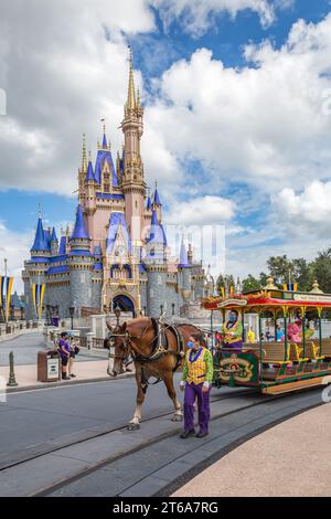 Piglet character rides a horse drawn trolley past Cinderella's Castle ...