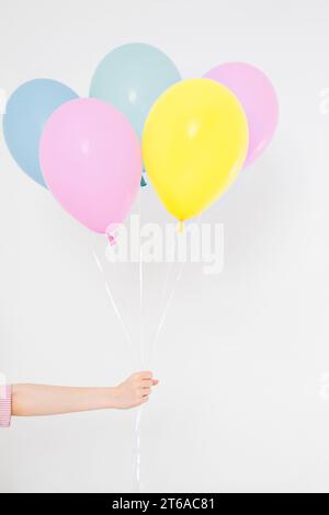 Hand holding balloons. Holiday concept. Colorful party balloons ...