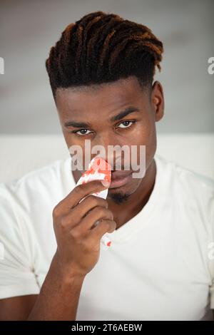 nosebleed , A man is bleeding from his nose Stock Photo - Alamy