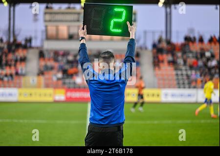 Sideline referee shows 4 minutes added time during the football match ...