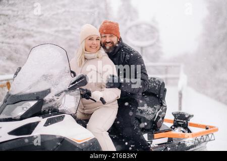 girl sitting on a snowmobile Stock Photo - Alamy