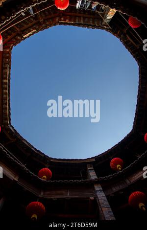 The sky above the round buildings of Hekeng Tulou Cluster in the early ...