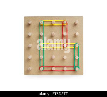 Wooden geoboard with letter S made of rubber bands on artificial grass ...