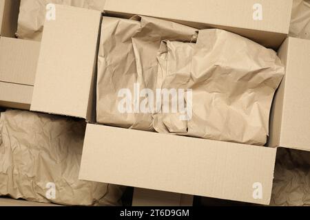Many open cardboard boxes with crumpled paper as background Stock Photo ...