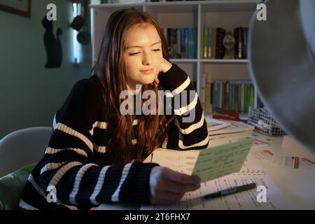 Teenage girl revising using flashcards and notes at her desk Stock ...