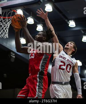 New Mexico center Nelly Junior Joseph drives around UNLV forward ...