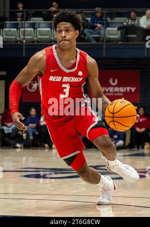 New Mexico guard Tru Washington dribbles around UNLV's Jeremiah Cherry ...