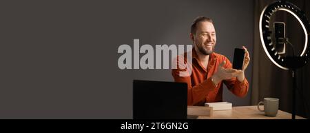 Male tech vlogger doing unpacking review video of mobile phone while ...