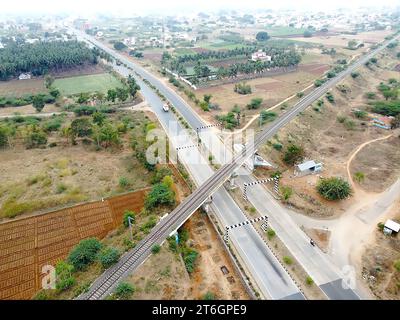 crossing of Railway track and highway roads Stock Photo - Alamy