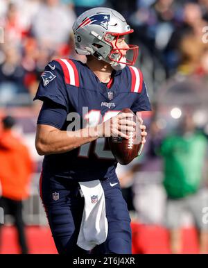 New England Patriots quarterback Mac Jones (10) looks to pass during an ...