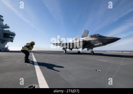 US Navy Flight Deck Handler, Lt. Cmdr. looks over the Ouija Board, a ...