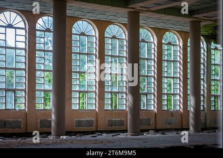 Glass wall inside of an abandoned garden pavilion. Empty abandoned ...