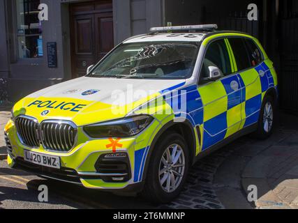 Police car with blue and yellow hi vis checkered livery Stock Photo - Alamy