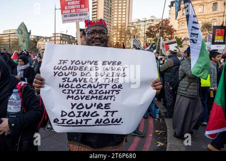 Protestors march with placards and flags during the Stop Bombing Iran ...