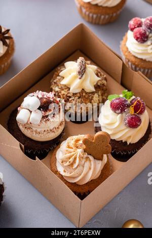 Tasty cupcakes with Christmas decor and gingerbread cookies on white ...