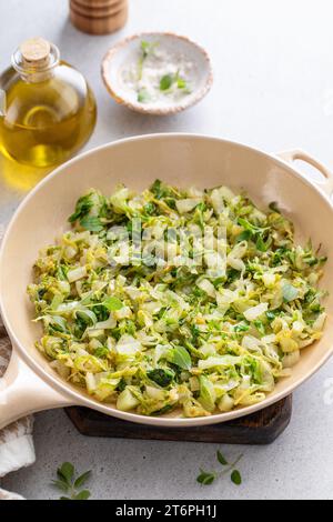 Sauteed cabbage with herbs in a cast iron pan, healthy vegetable side ...