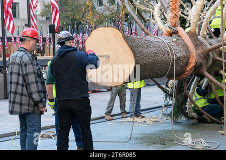 Workers drill to install spike into The Rockefeller Center Christmas ...