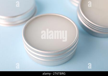Lip balms on light blue background, closeup. Space for text Stock Photo ...