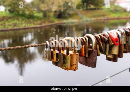 A string of many keys attached to a metal rope with a brown aqua ...