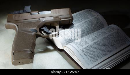 Trigger section of semi automatic pistol against a balck background ...