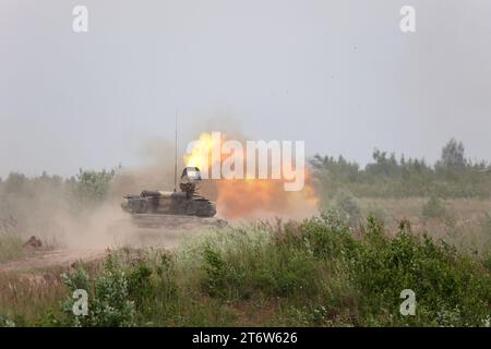 Fire and smoke from a tank shot during training at the training ground ...