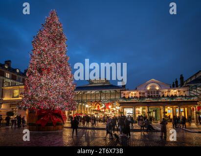 People walk past a Christmas tree decorated in ornaments in Manhattan ...