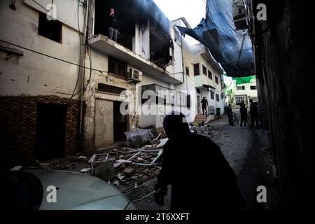 Palestinians inspect damaged buildings after an Israeli military raid ...