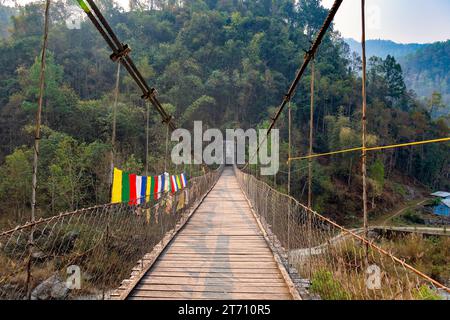 Hanging wooden bridge on Railey river surrounded by mountains at ...
