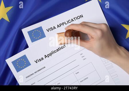 Immigration to European Union. Woman stamping visa application forms on ...