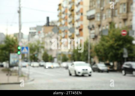 Blurred view of quiet city with buildings and cars on road Stock Photo ...