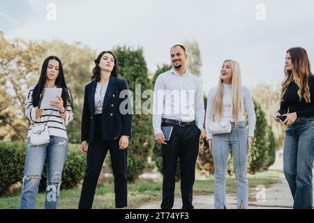 University colleagues prepare for exams in a park, discussing subject ...