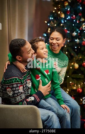 Parents and child smiling and hugging warmly, showing love and ...