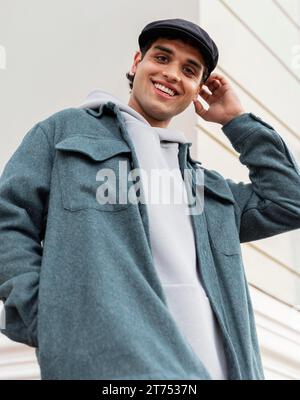 Medium shot smiley man looking tablet Stock Photo - Alamy