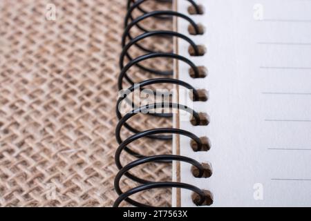Brown color spiral notebook placed on a canvas background Stock Photo ...