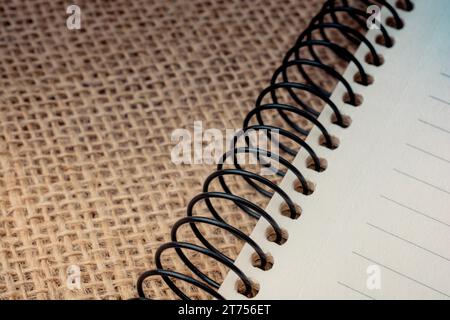 Brown color spiral notebook placed on a canvas background Stock Photo ...