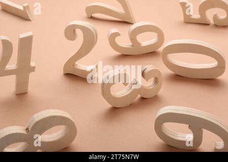 Many different wooden numbers on beige background Stock Photo - Alamy