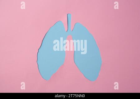 Paper in shape of human lungs on light blue crumpled background, top ...